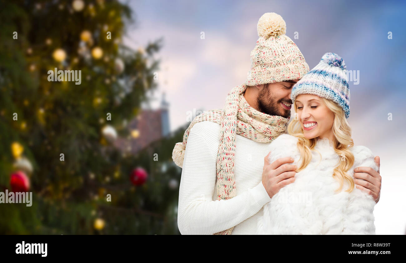 happy couple hugging over christmas tree Stock Photo - Alamy