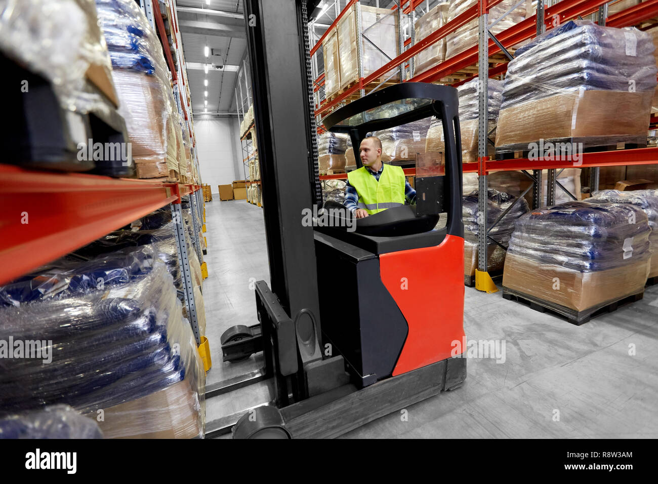 male loader operating forklift at warehouse Stock Photo - Alamy