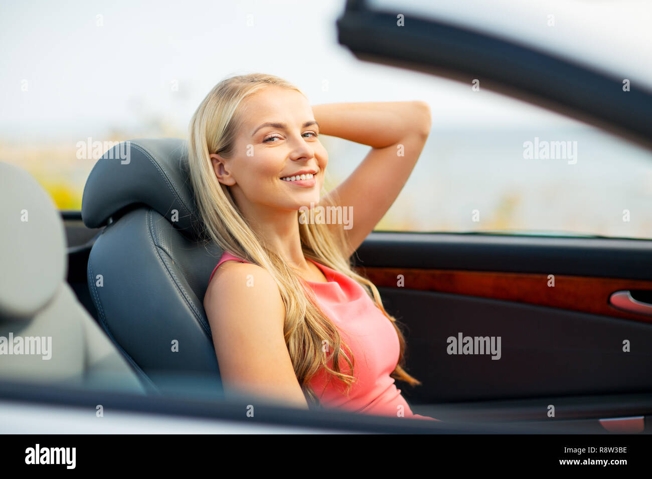 happy young woman driving convertible car Stock Photo - Alamy