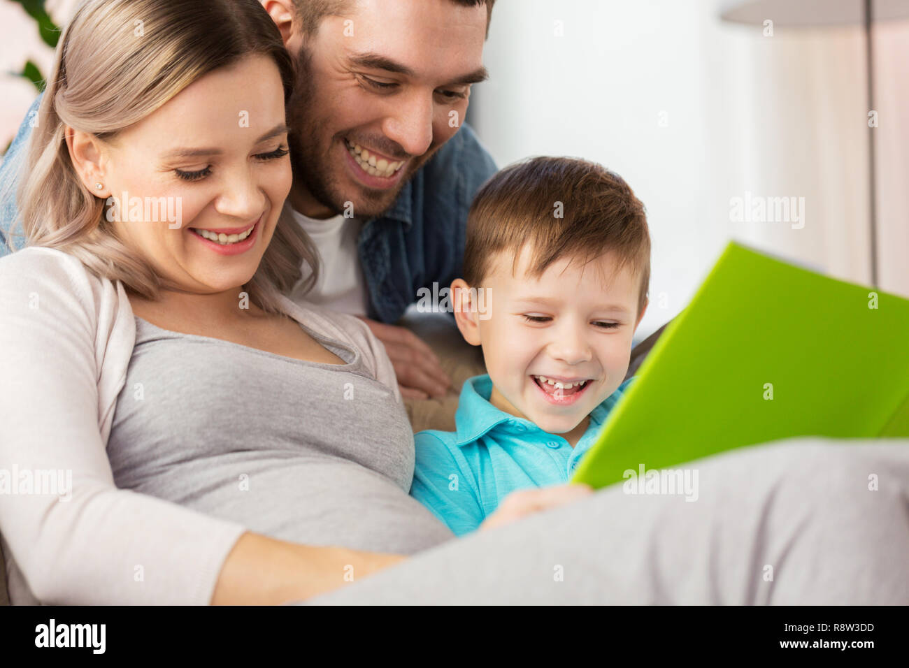 happy family reading book at home Stock Photo - Alamy