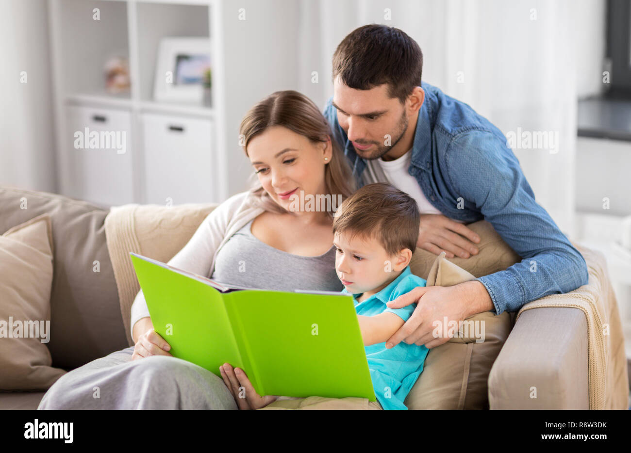 happy family reading book at home Stock Photo - Alamy