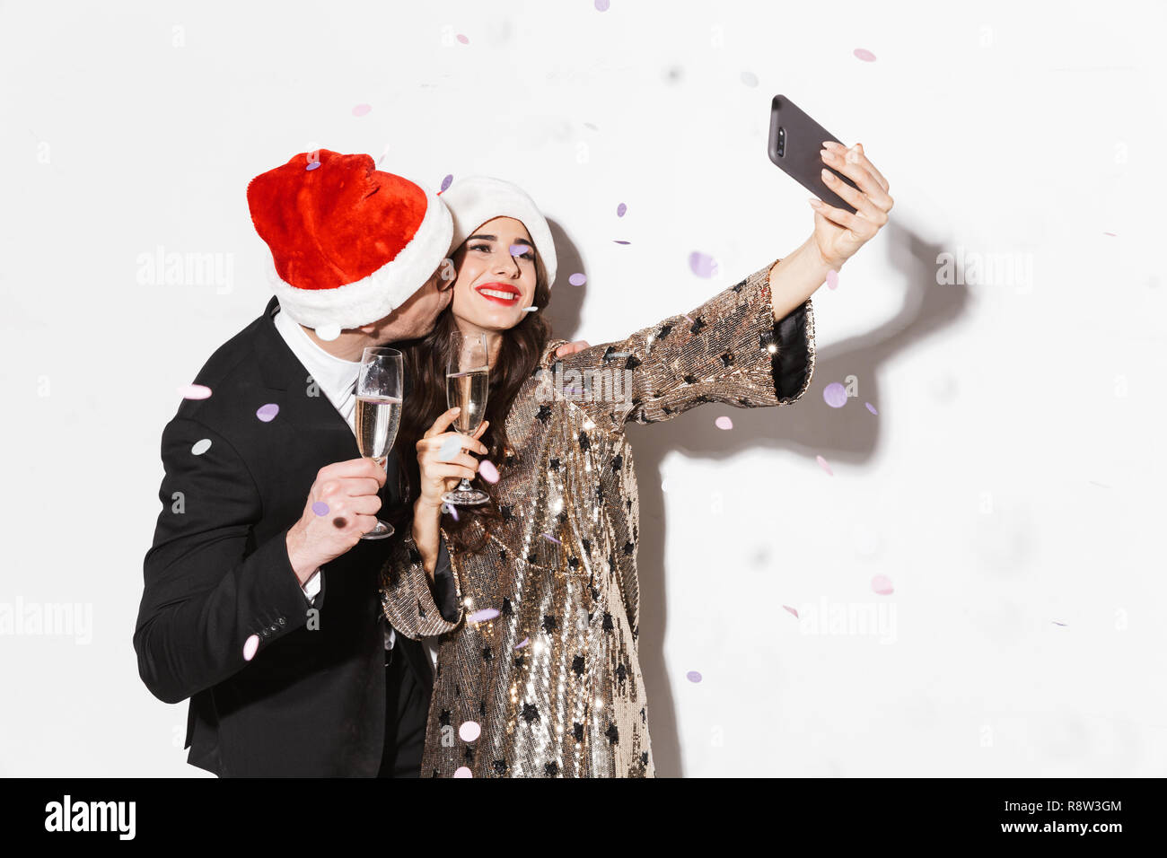 Cheerful young smartly dressed couple celebrating New Year party ...