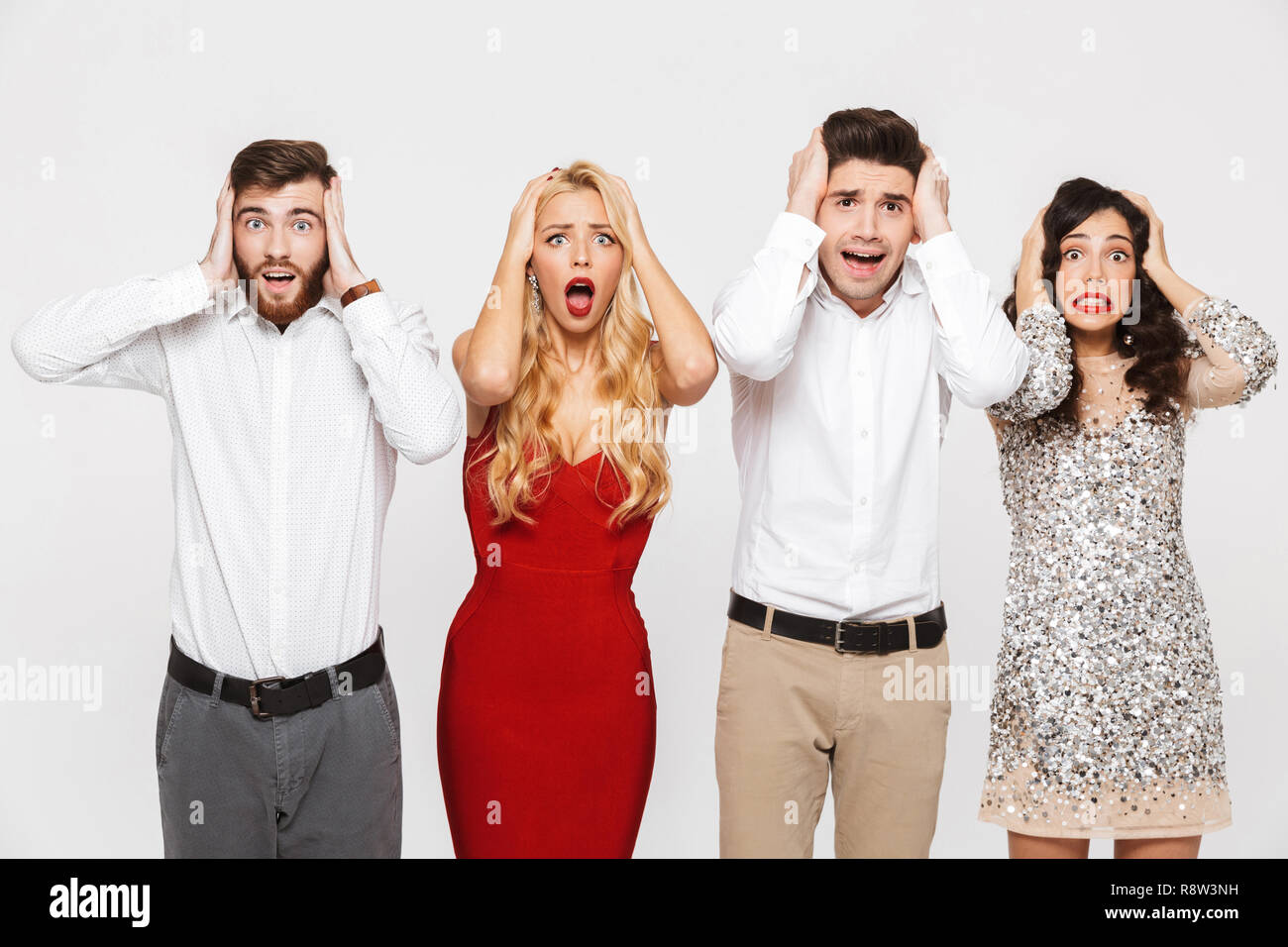 Image of a shocked excited young group of friends standing isolated ...