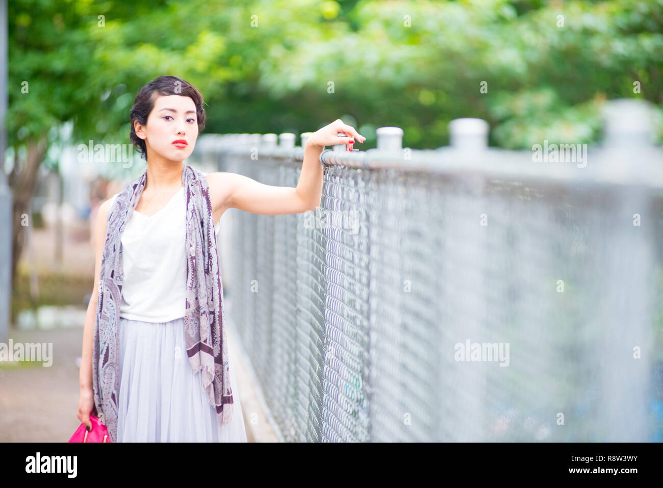 Asian female model poses for pictures in the cityscape Stock Photo - Alamy