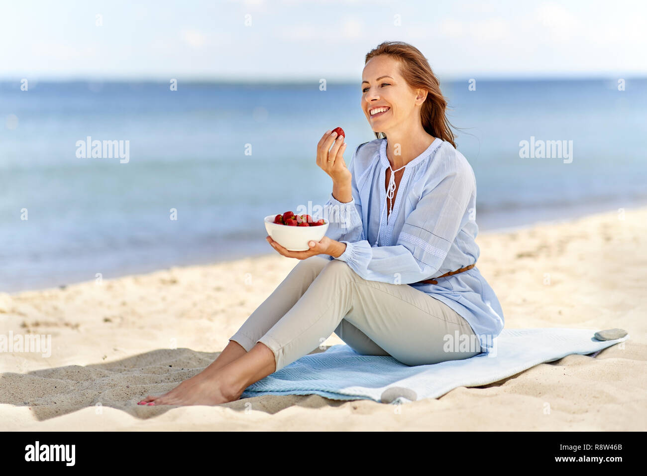 Woman beach eating fruit not fruits hi-res stock photography and images ...