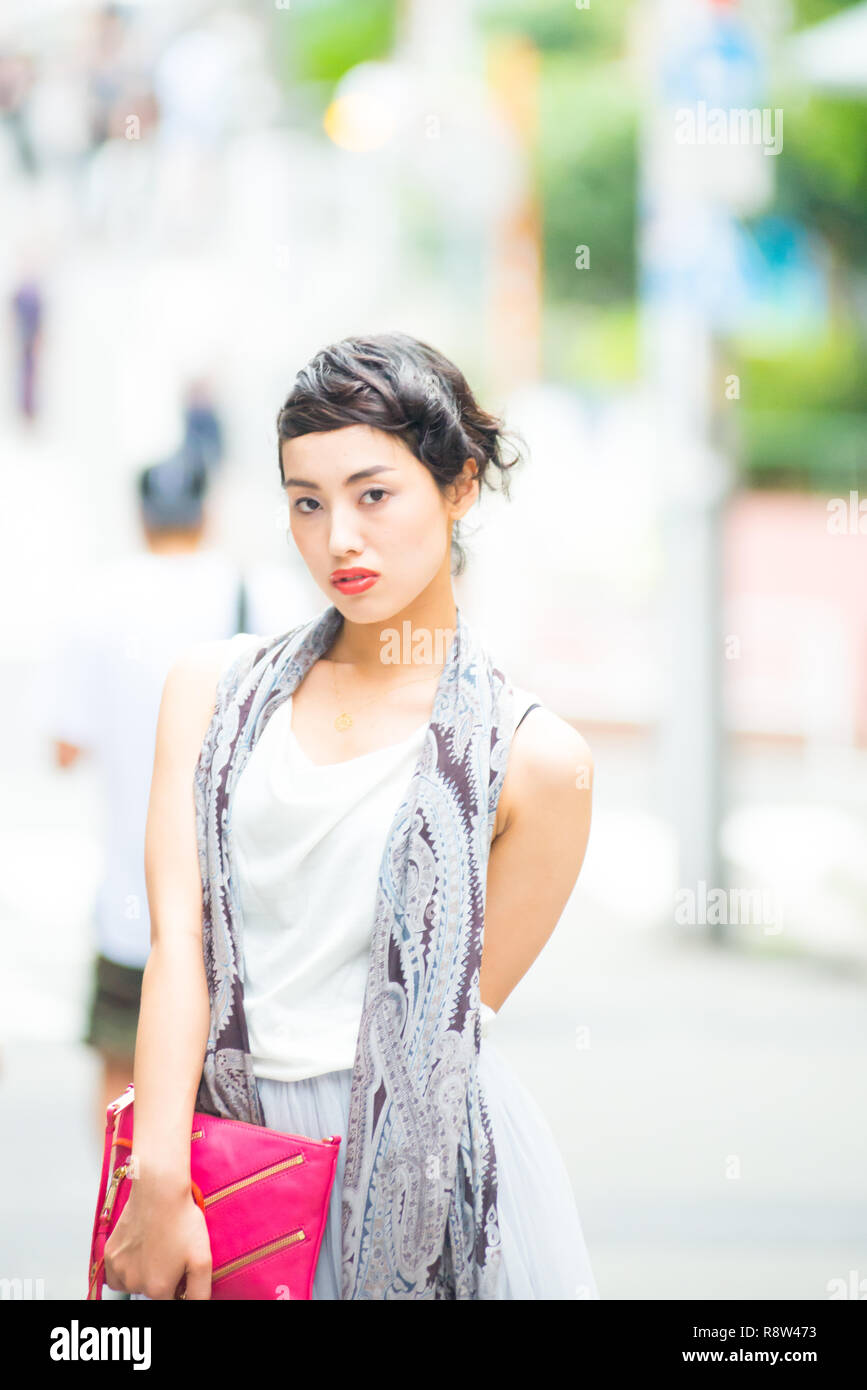 Asian female model poses for pictures in the cityscape Stock Photo - Alamy