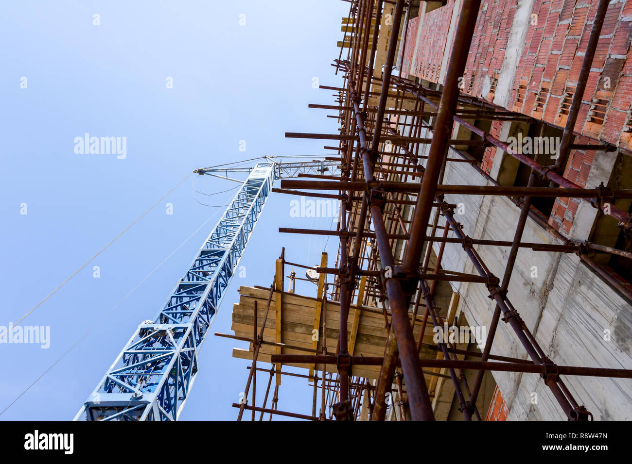 Scaffold and crane are placed against unfinished edifice, building ...
