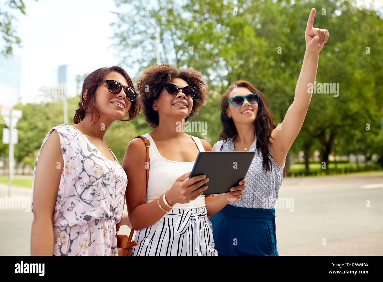 women with tablet pc on street in summer Stock Photo - Alamy