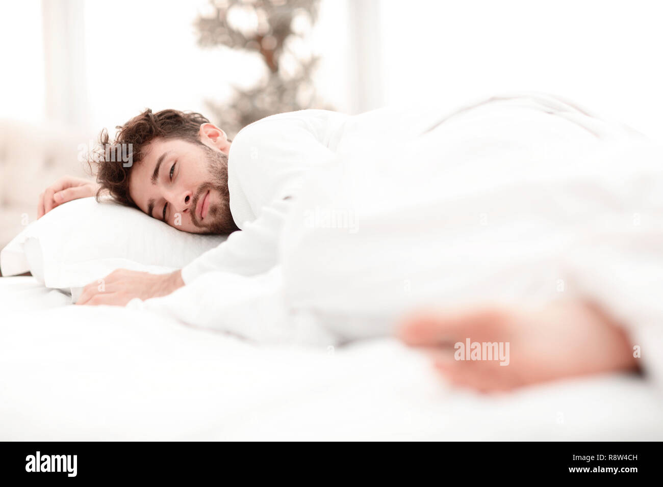 closeup.the tired men sleep soundly on the bed Stock Photo - Alamy