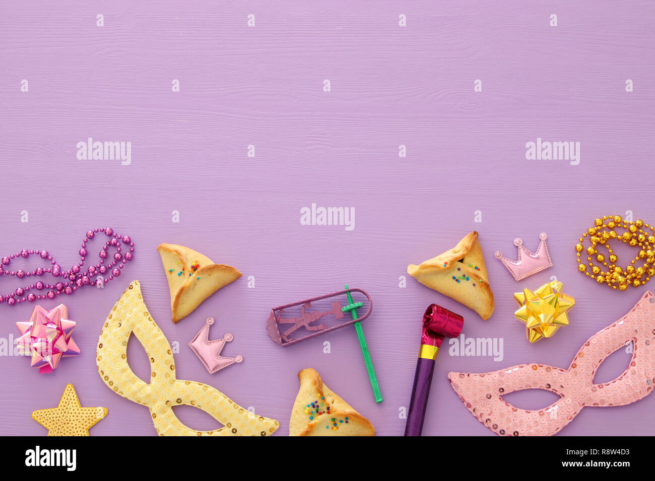 Purim celebration concept (jewish carnival holiday) over pink, purple ...