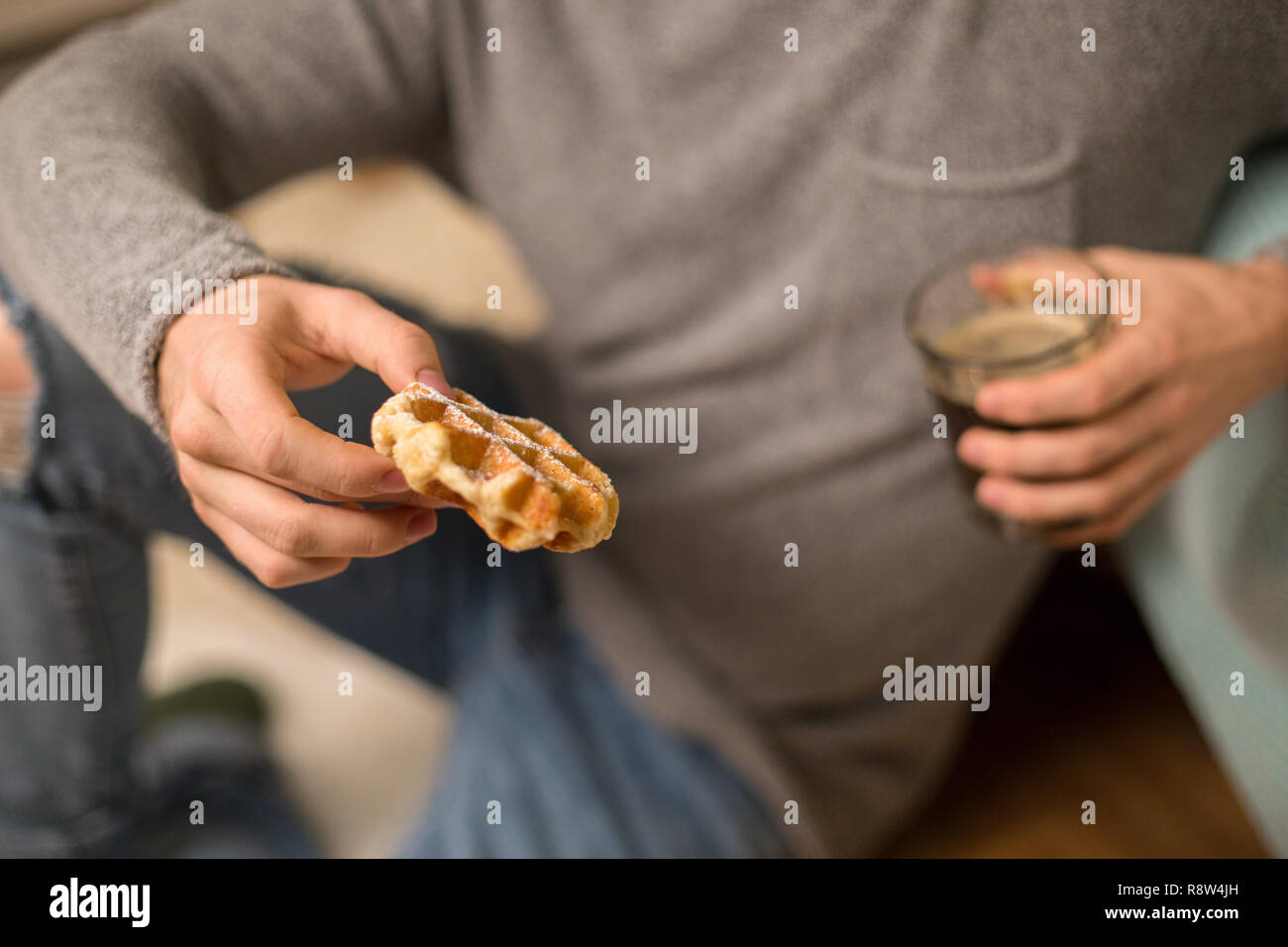 close up of man eating waffle with coffee at home Stock Photo - Alamy