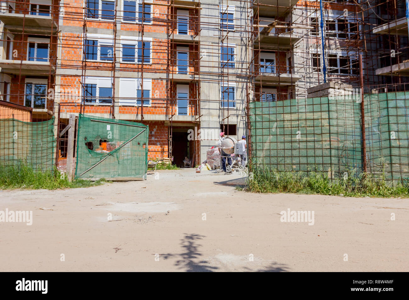 Dusty ground is in front of entrance the building site. Restricted area ...