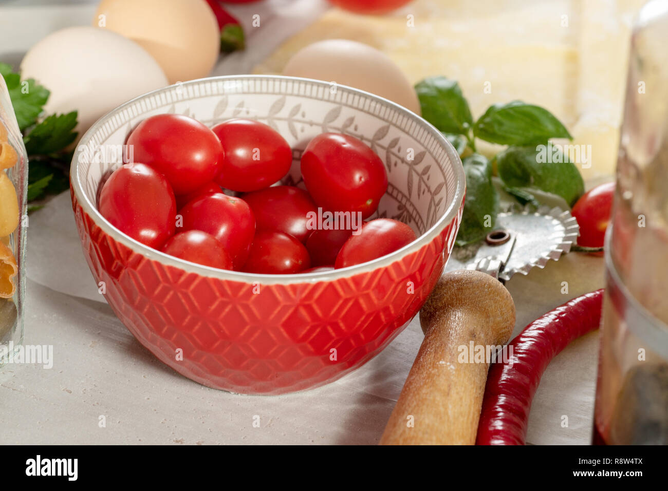 the cherry tomatoes in a small red bowl Stock Photo - Alamy