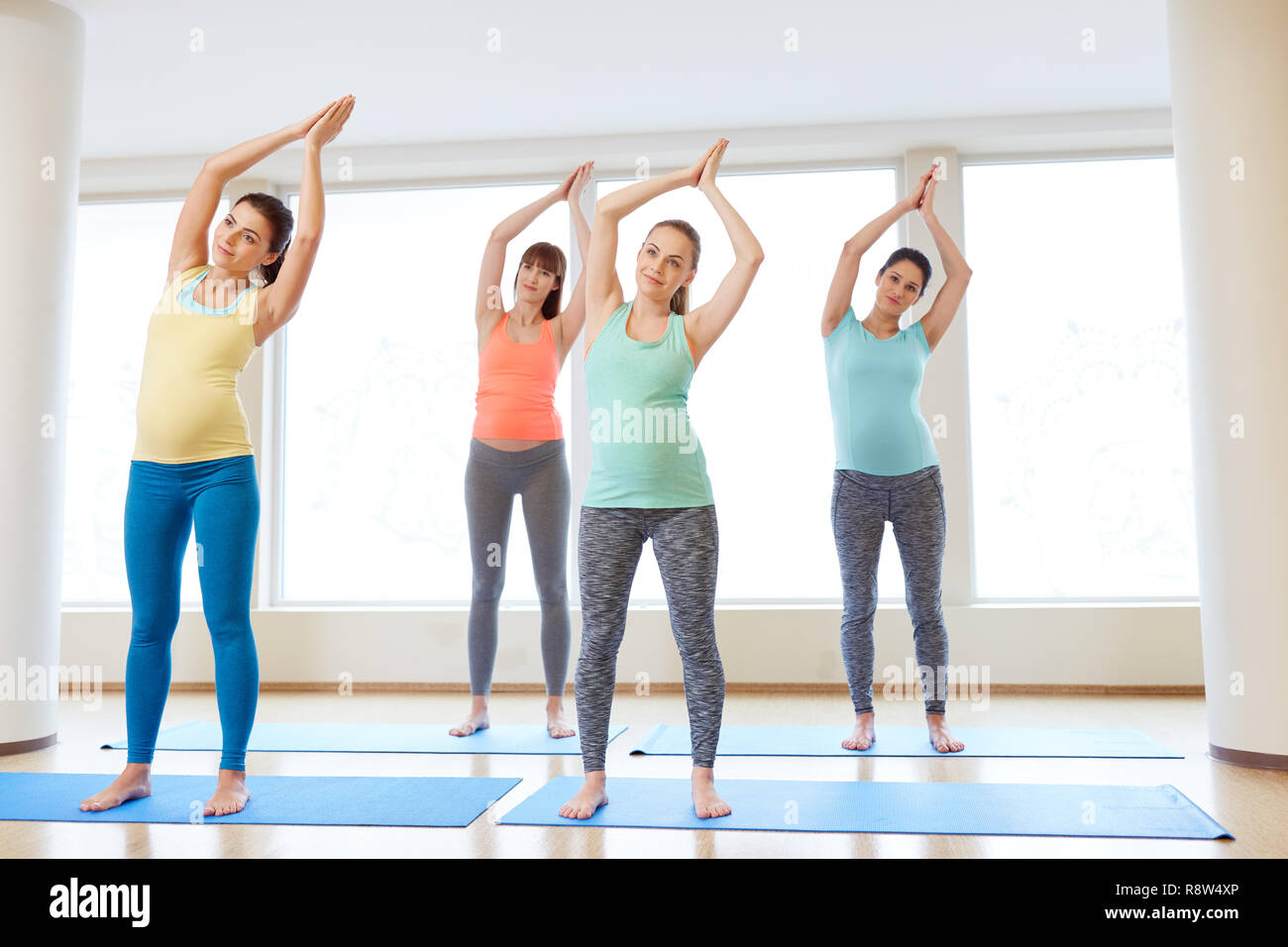 Group happy pregnant women exercising hi-res stock photography and ...