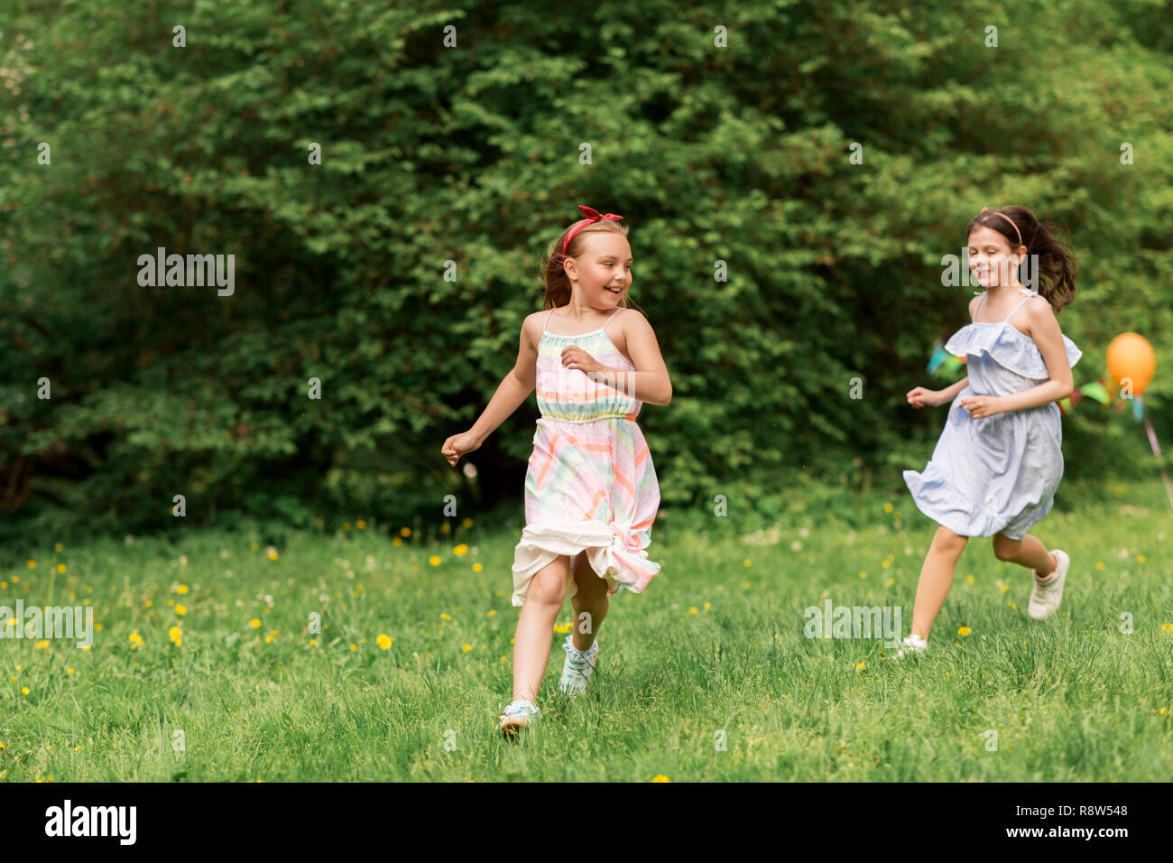 happy girls playing tag game at birthday party Stock Photo - Alamy