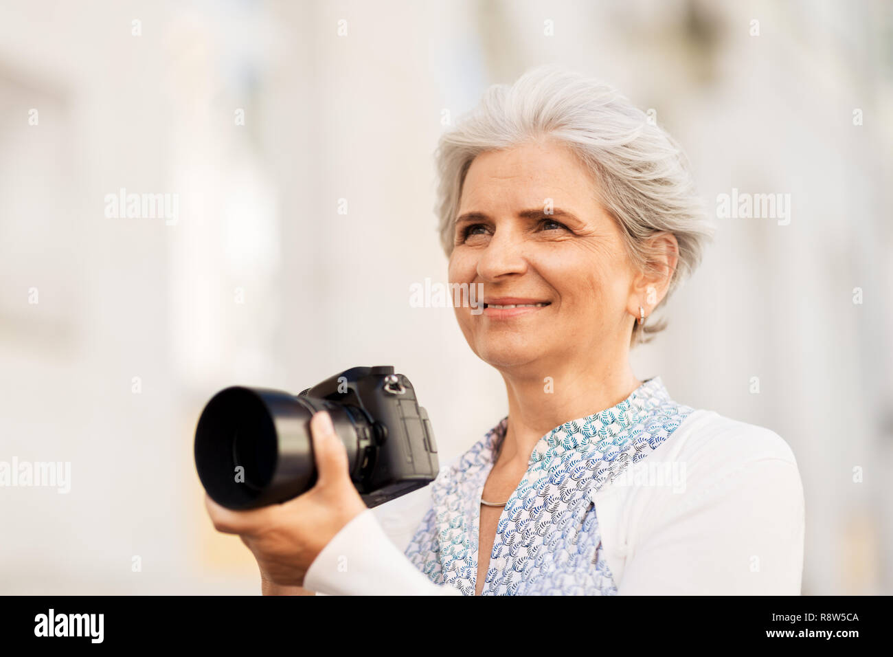 senior woman photographing by digital camera Stock Photo - Alamy