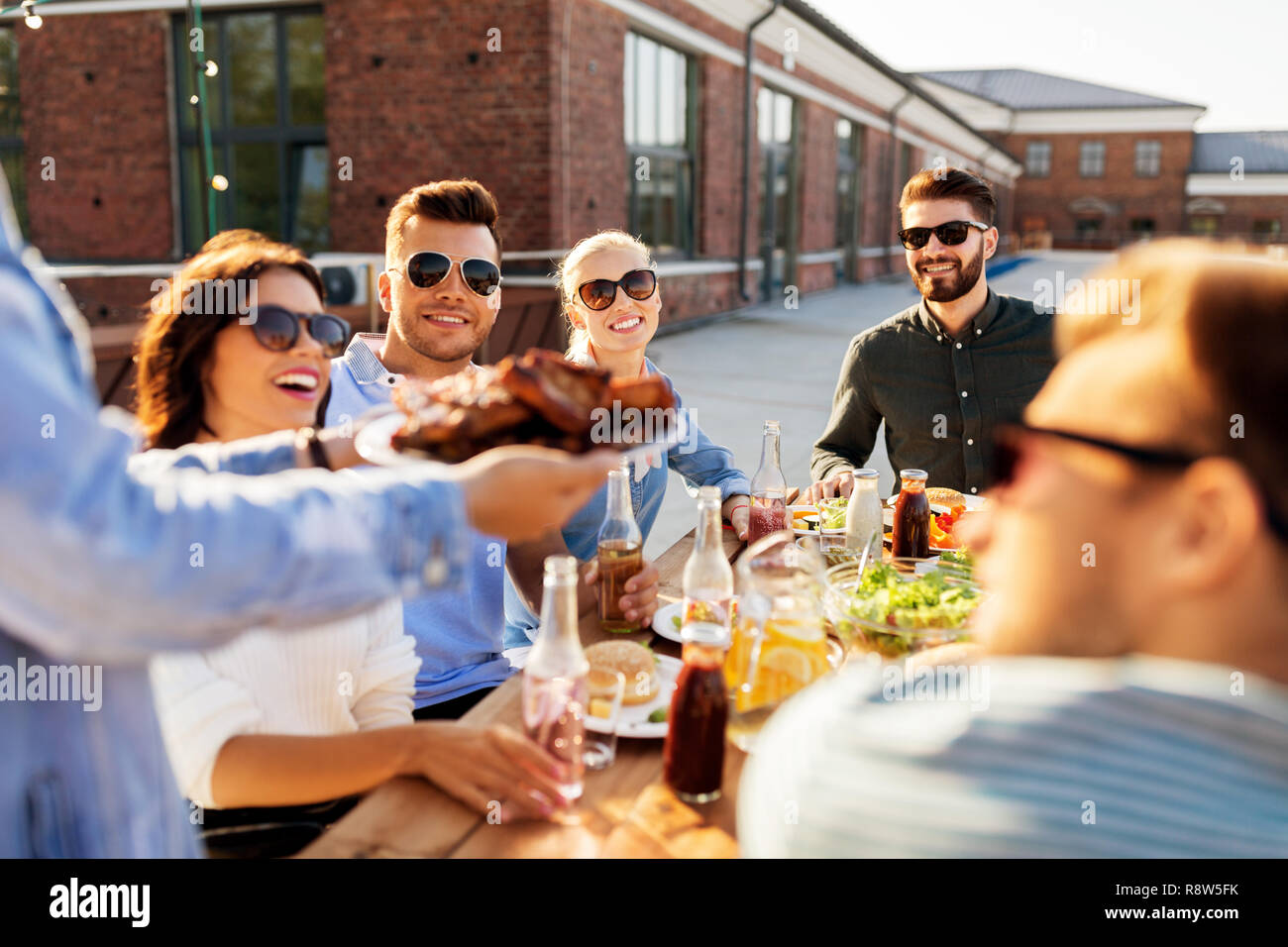 friends at barbecue party on rooftop in summer Stock Photo - Alamy