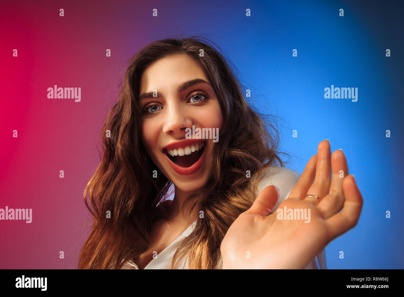 Happy woman standing, smiling on colored studio background. Beautiful ...