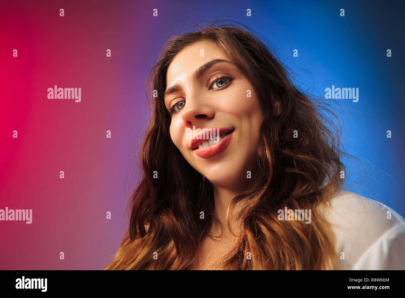 Happy woman standing, smiling on colored studio background. Beautiful ...