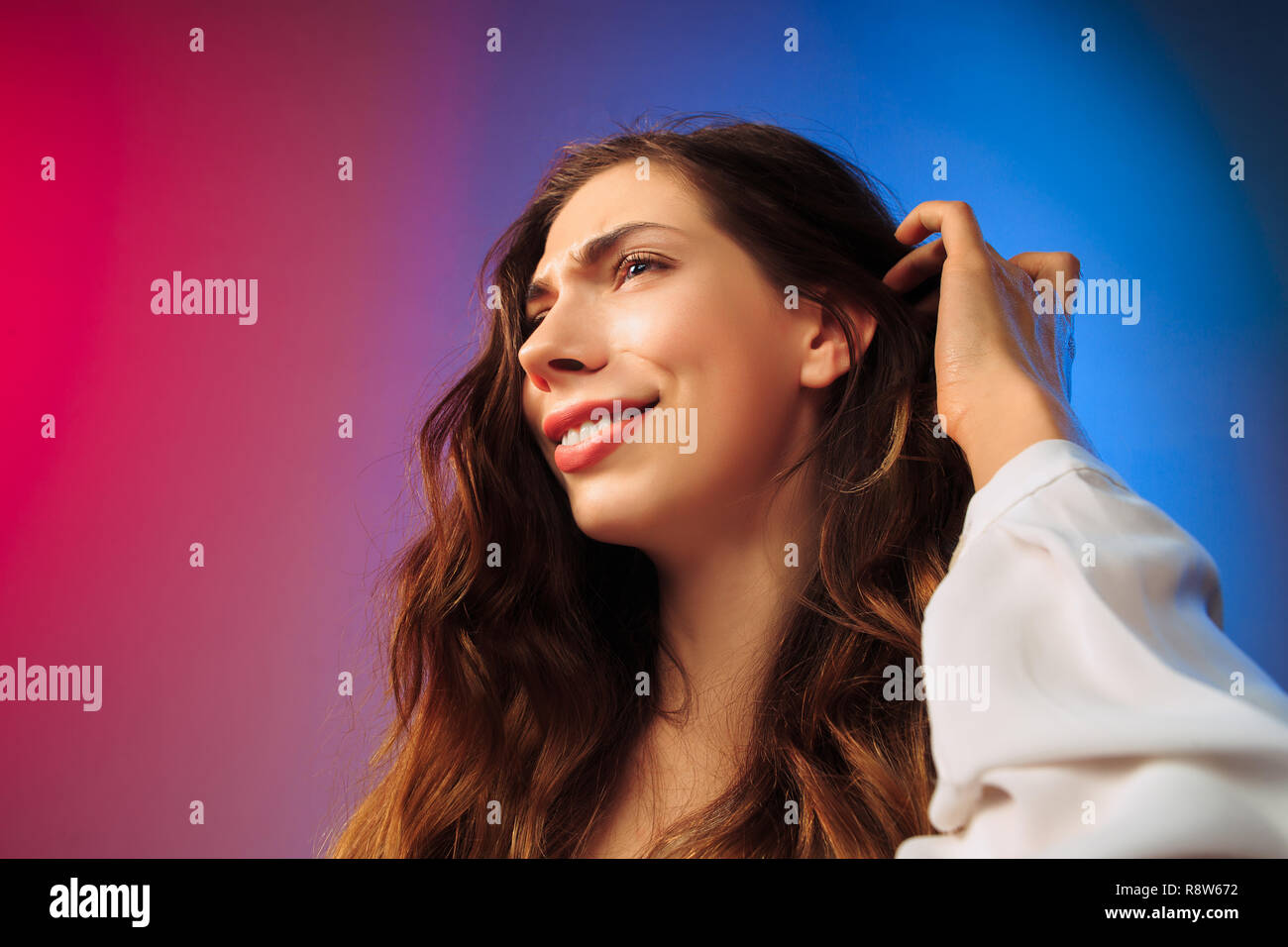 Happy woman standing, smiling on colored studio background. Beautiful ...