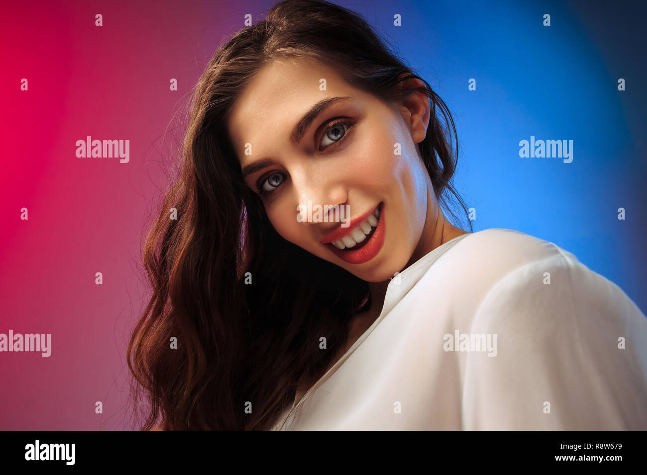 Happy woman standing, smiling on colored studio background. Beautiful ...