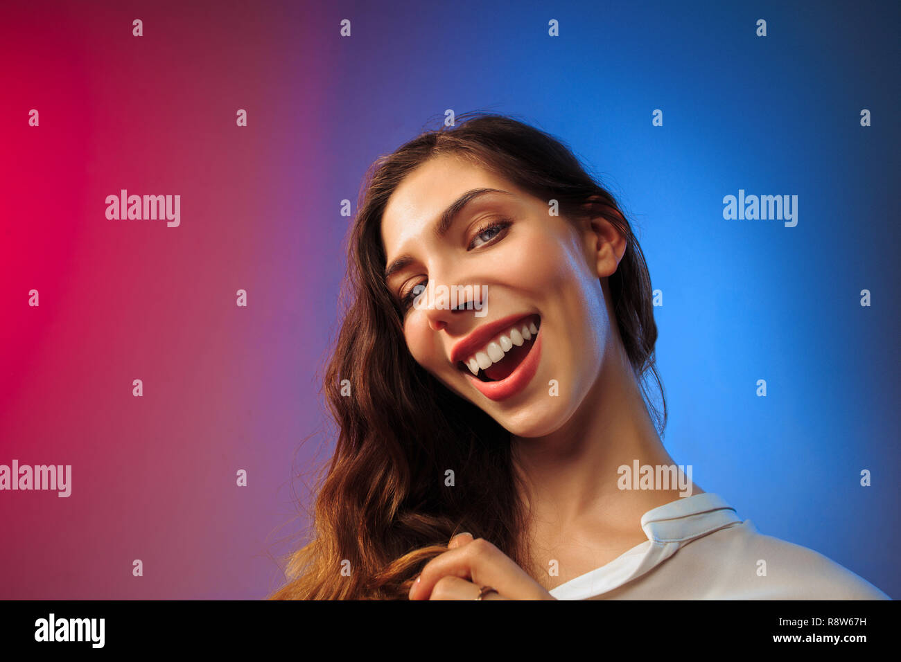 Happy woman standing, smiling on colored studio background. Beautiful ...