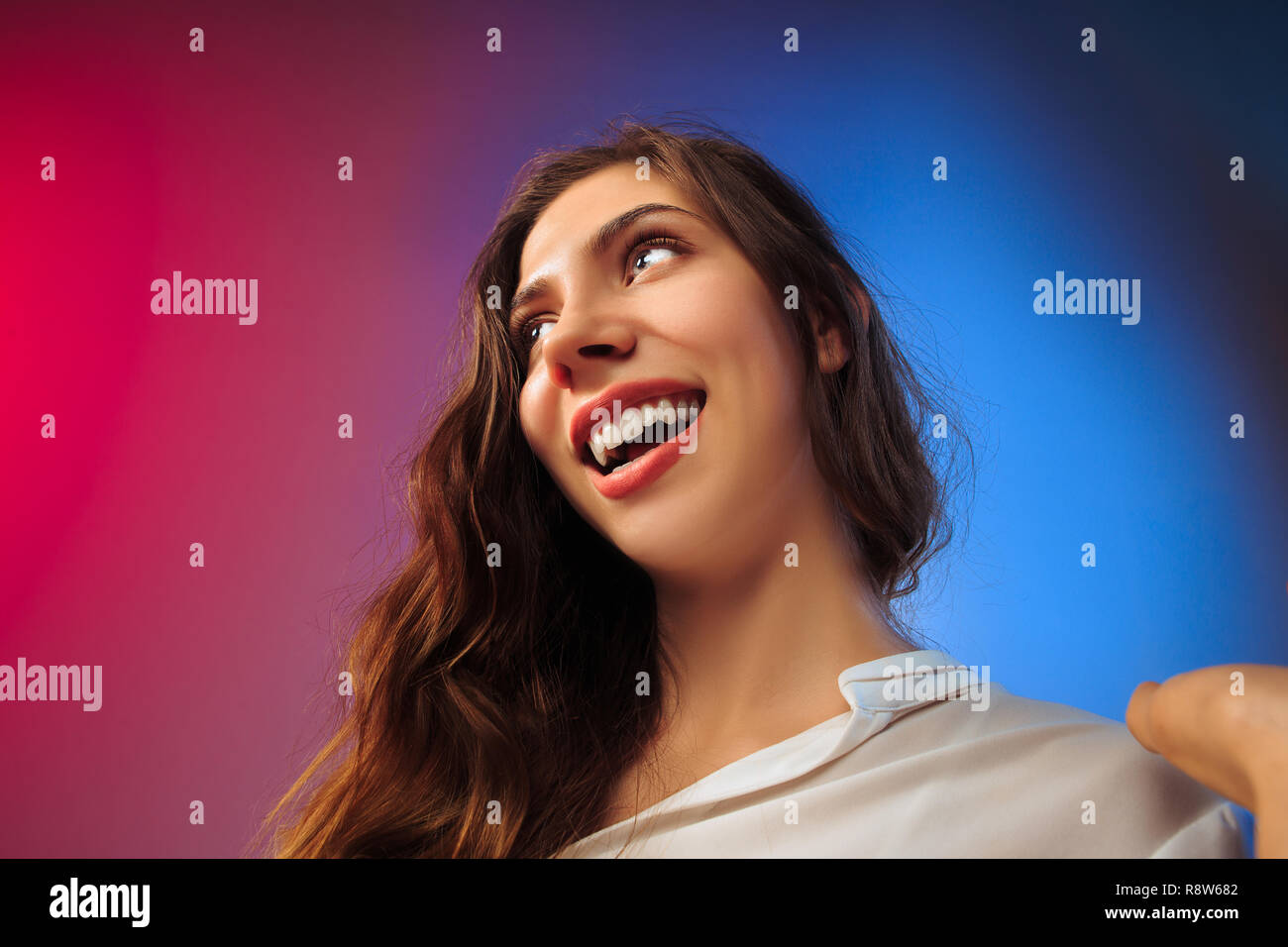Happy woman standing, smiling on colored studio background. Beautiful ...