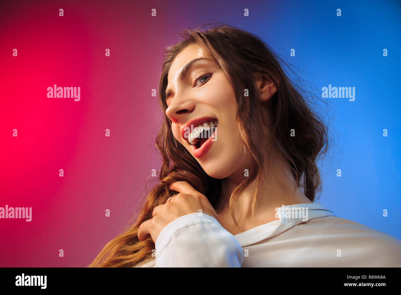 Happy woman standing, smiling on colored studio background. Beautiful ...