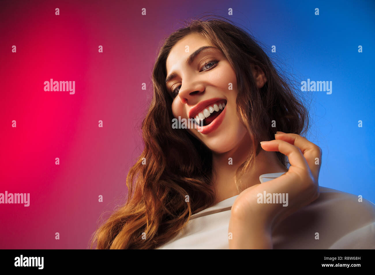 Happy woman standing, smiling on colored studio background. Beautiful ...