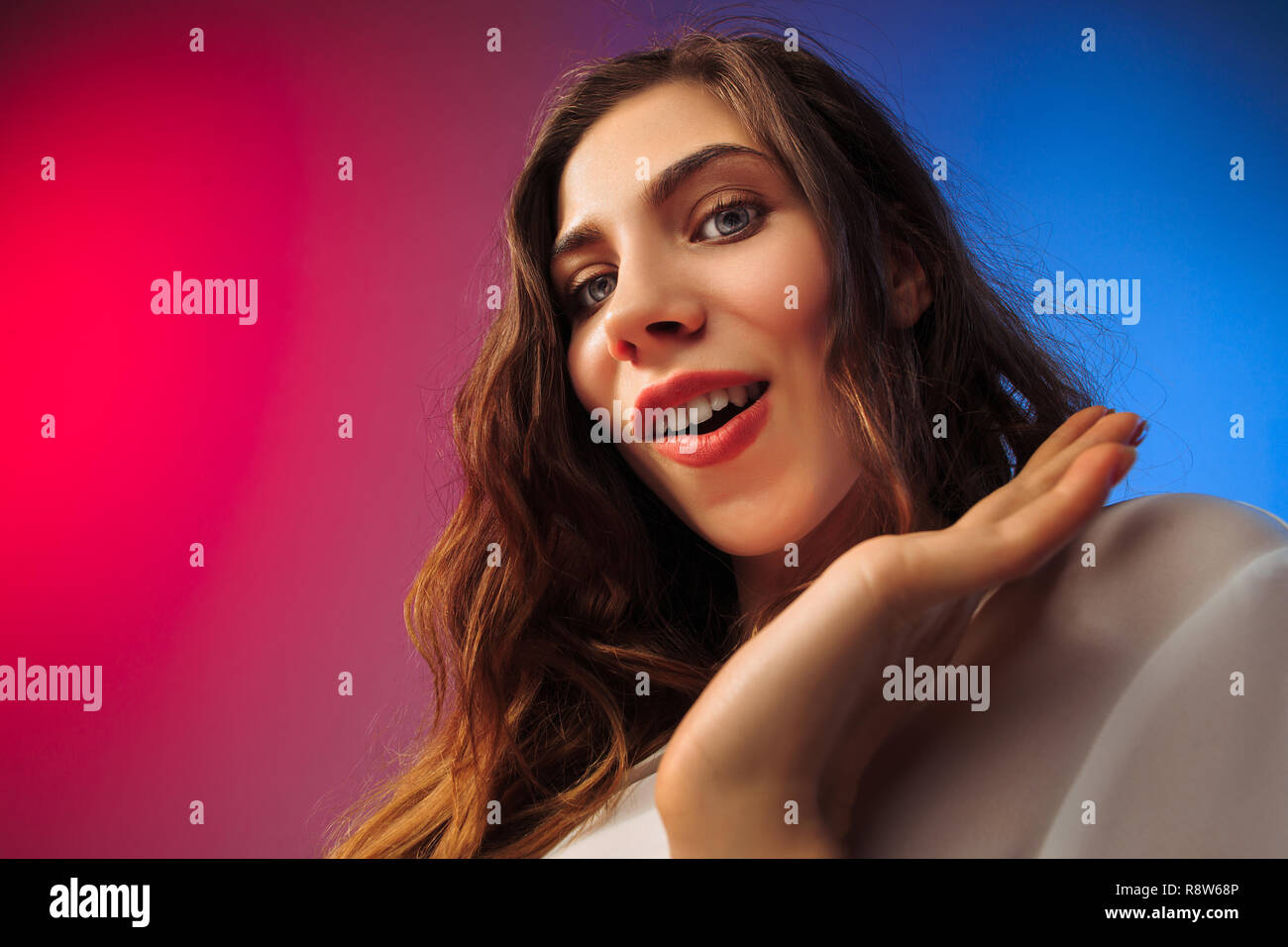 Happy woman standing, smiling on colored studio background. Beautiful ...