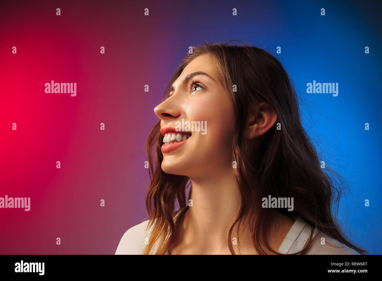 Happy woman standing, smiling on colored studio background. Beautiful ...