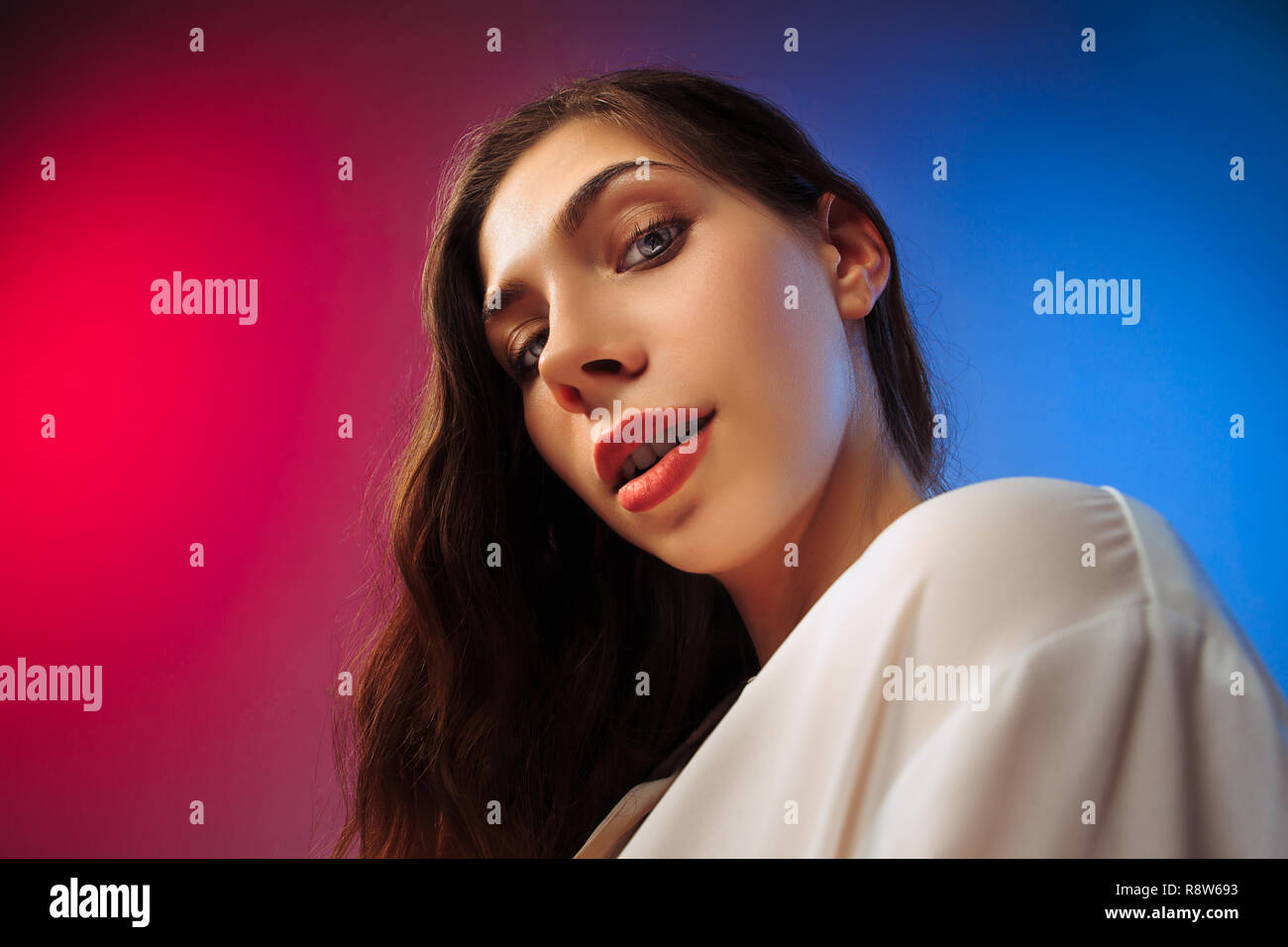 Happy woman standing, smiling on colored studio background. Beautiful ...