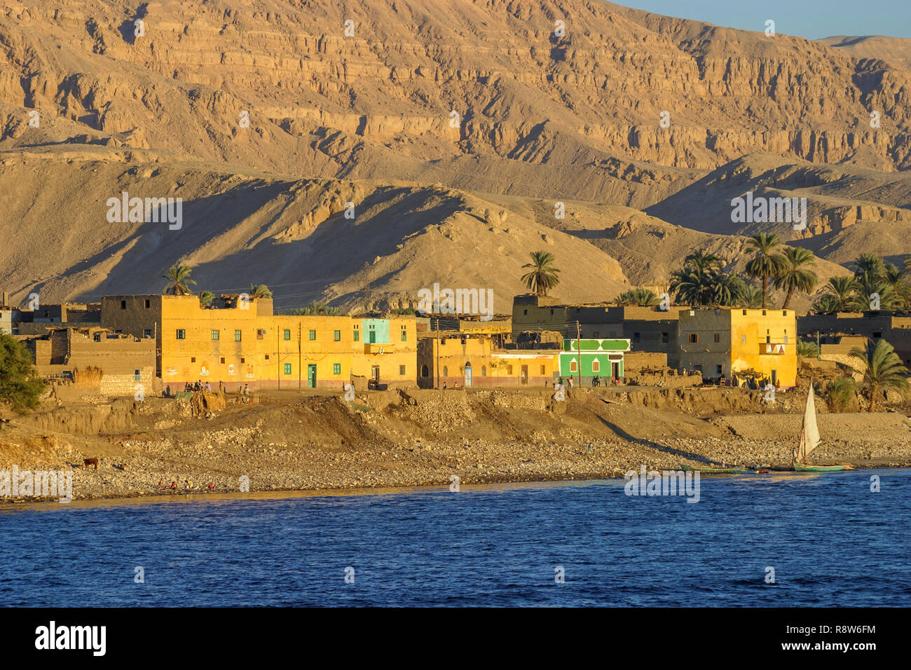 View of a typical small riverside village buildings on the banks of the ...