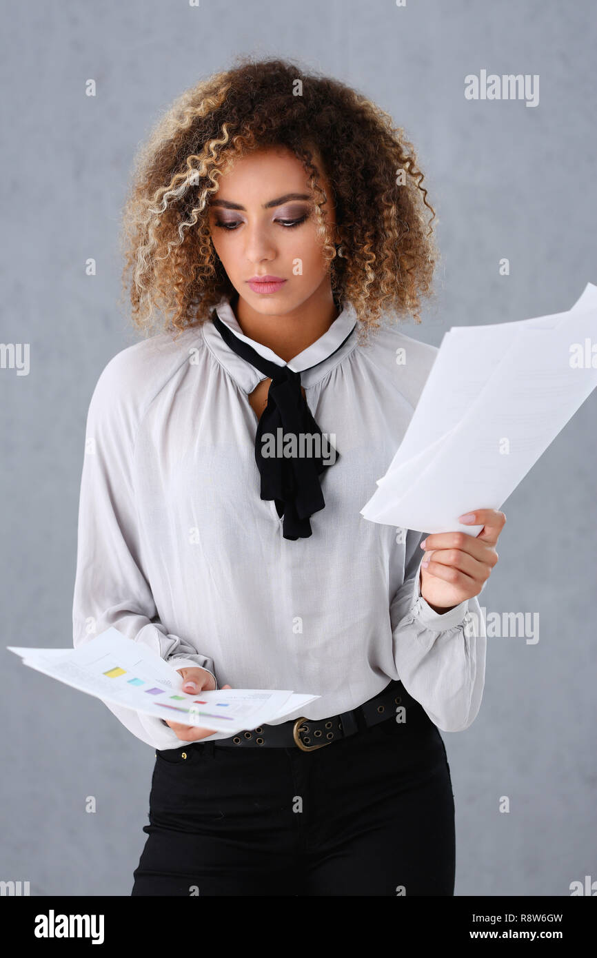 Beautiful black woman portrait. Holds paper documents Stock Photo - Alamy