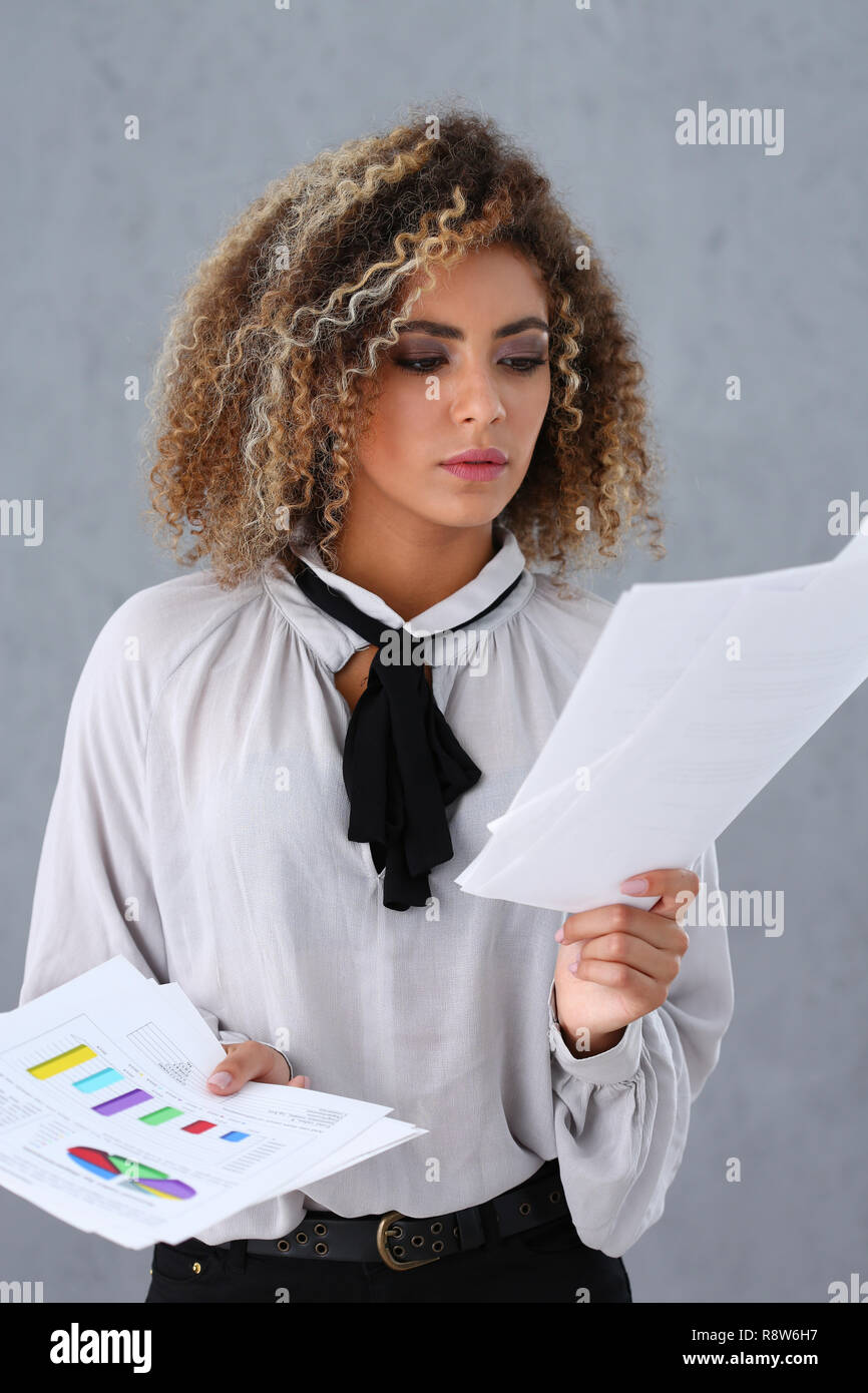 Beautiful black woman portrait. Holds paper documents Stock Photo - Alamy