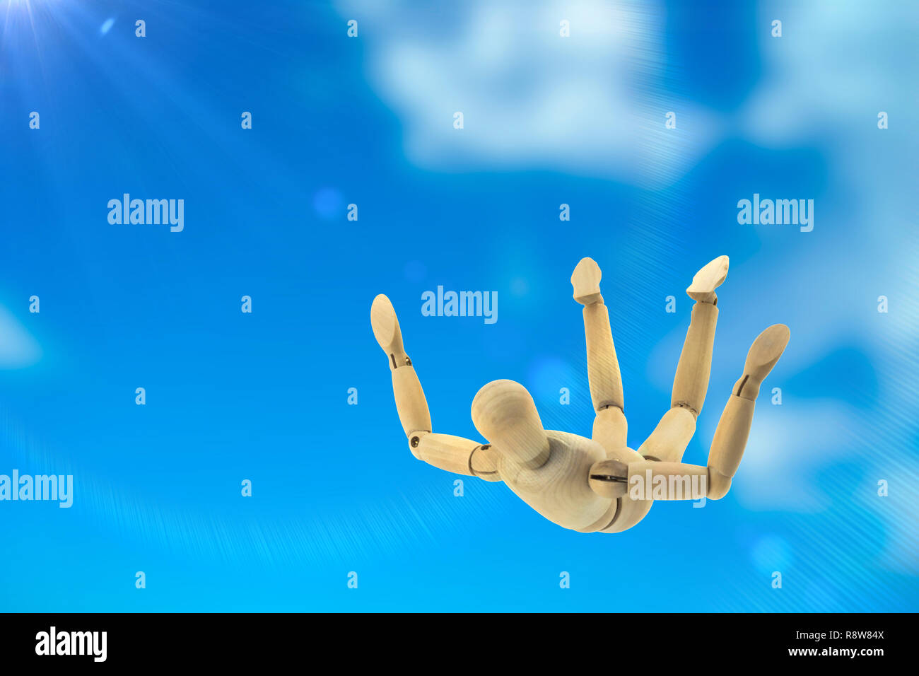 Doll wood flying in the sky in free fall, conceptual image Stock Photo ...