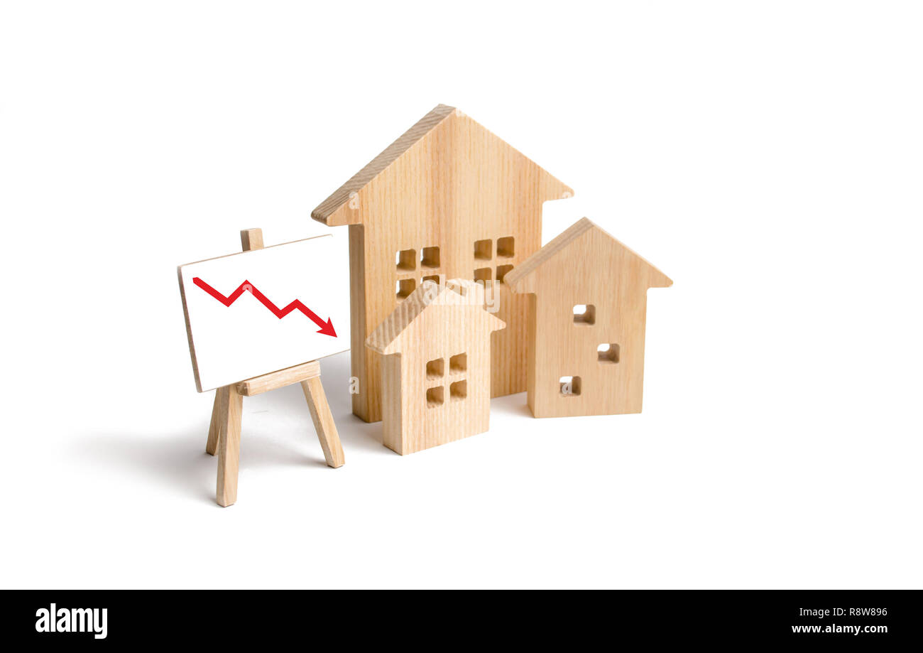 Figures Wooden houses and red arrow down. The concept of falling prices ...