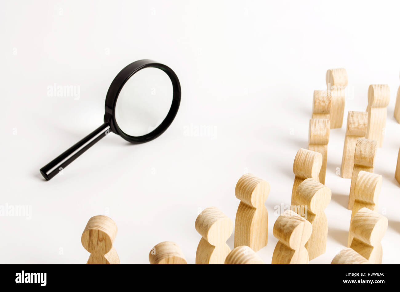 A crowd of people looking into a magnifying glass. Search and tracing ...