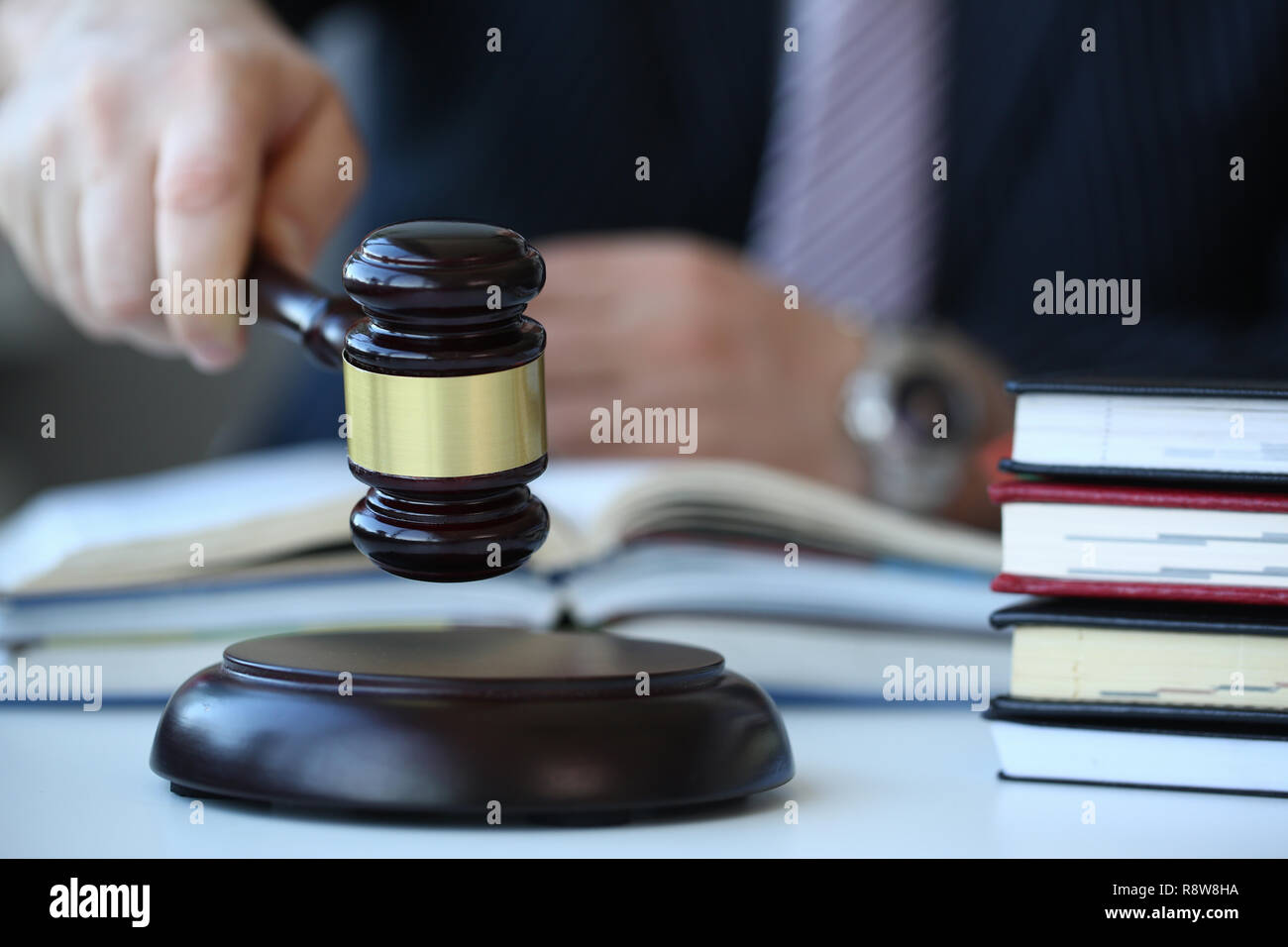Judge holding hammer in hand lies Stock Photo - Alamy