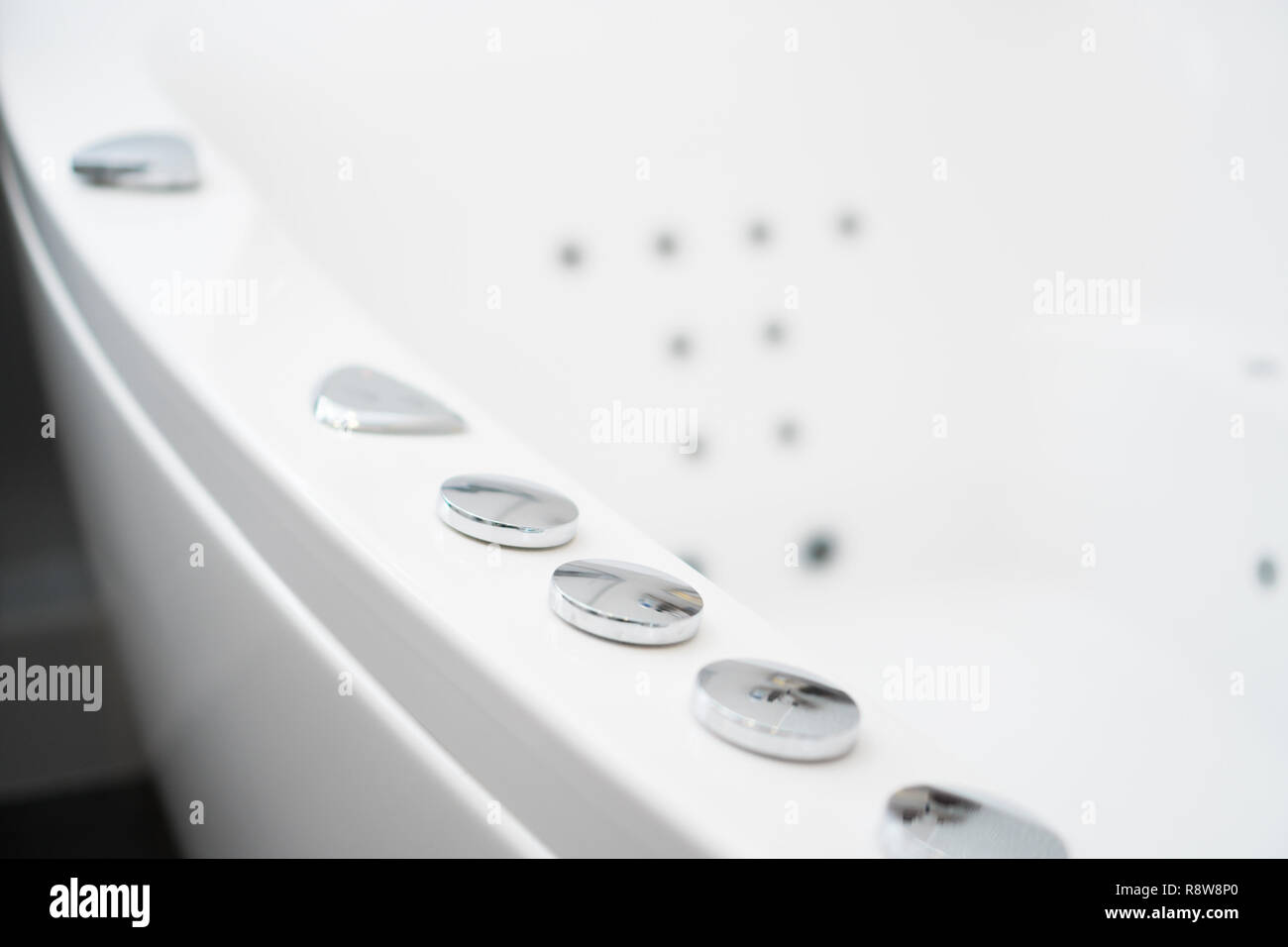 Hydromassage bathtub control buttons in bathroom Stock Photo - Alamy
