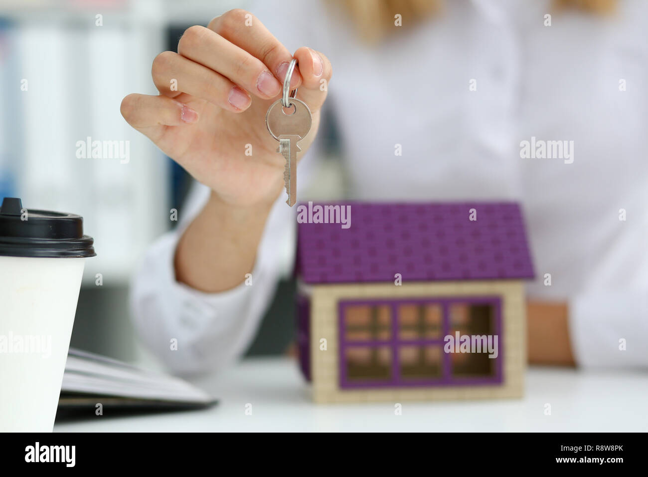Female hand holds the key to the lock in the hand Stock Photo - Alamy