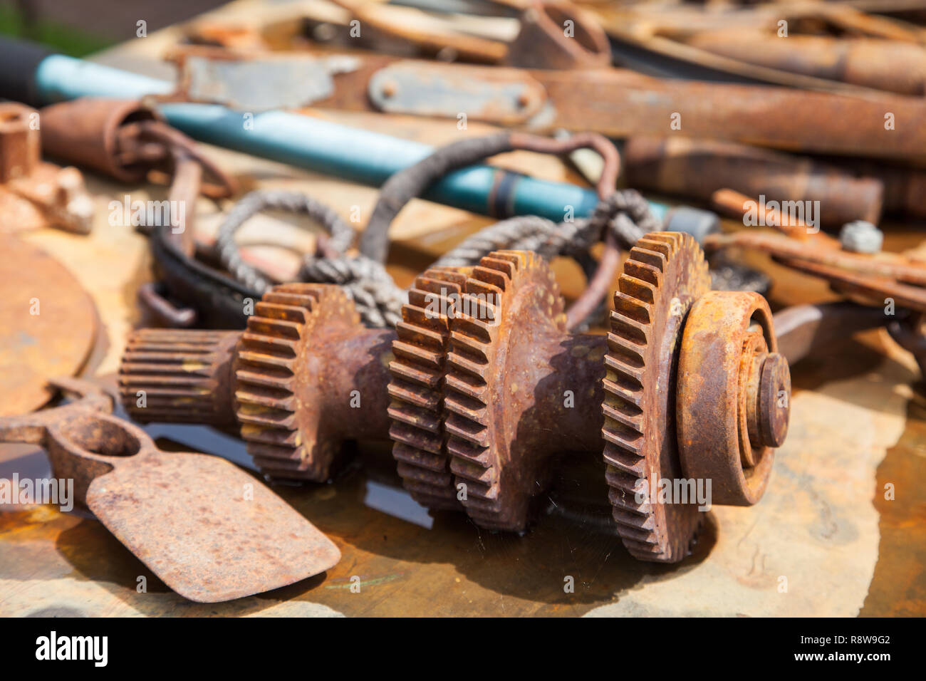 Junkyard with old rusty iron parts such as gearboxes and cogwheels ...
