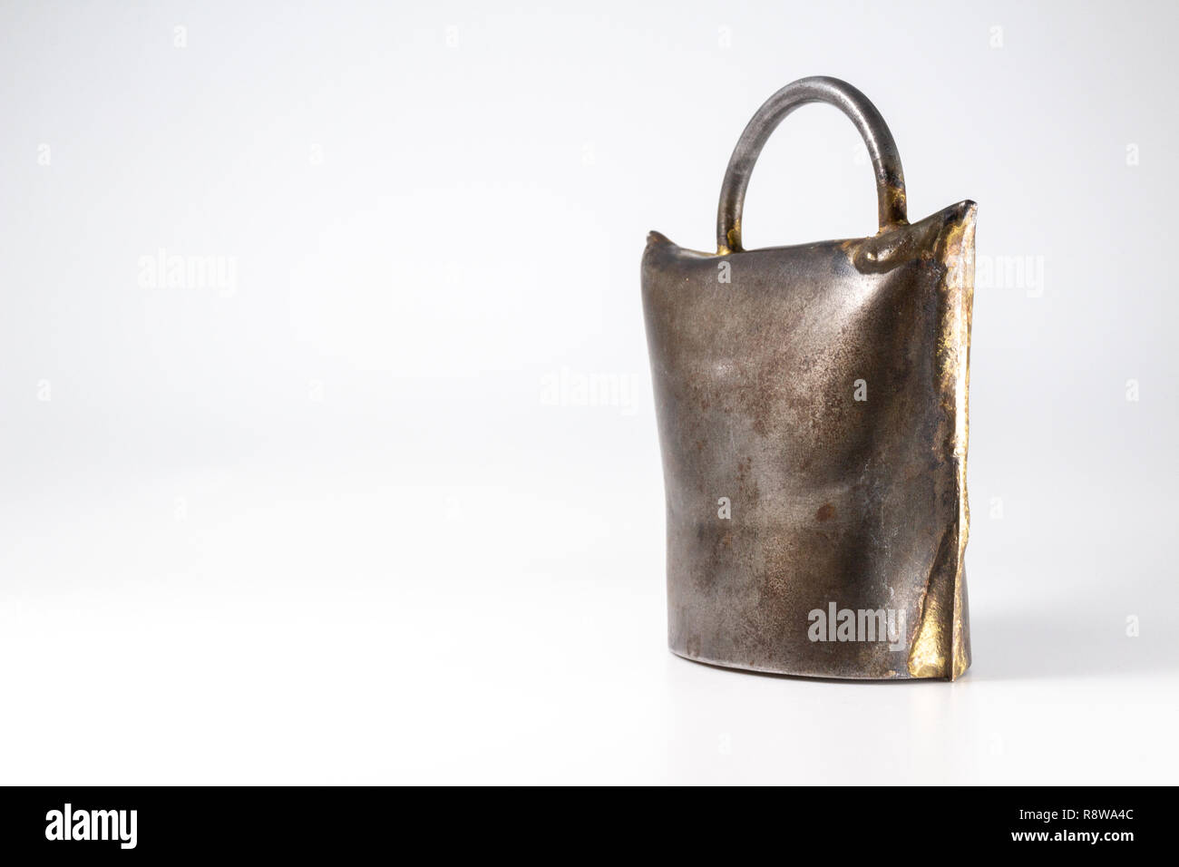 Metallic handmade cowbell, isolated in studio Stock Photo - Alamy