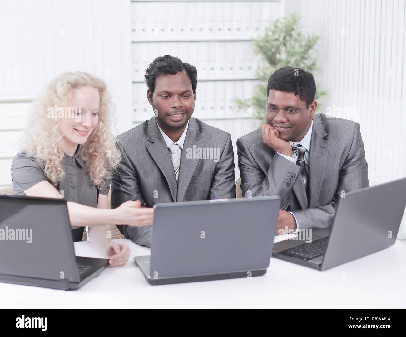 employees sitting on the workplace in the office Stock Photo - Alamy