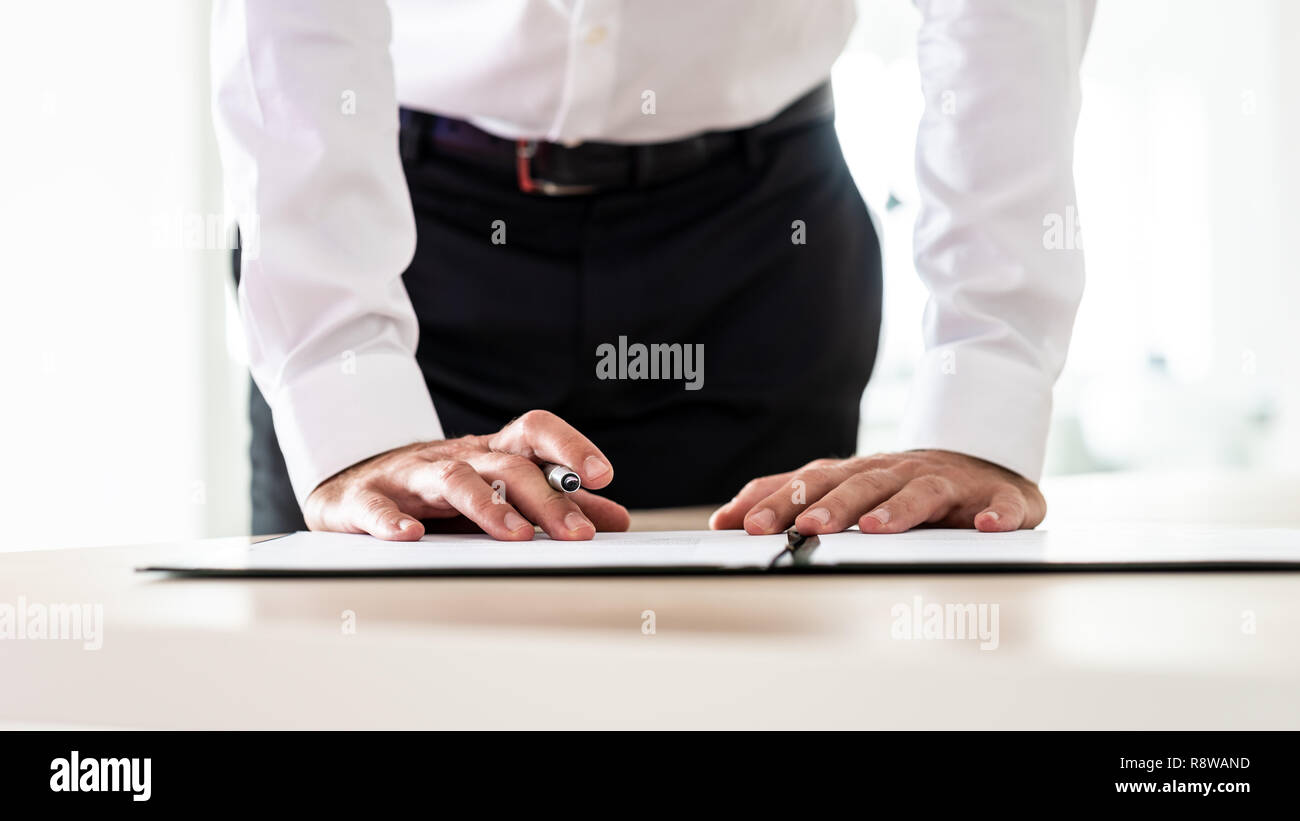 Business employer signing an application form or other important ...