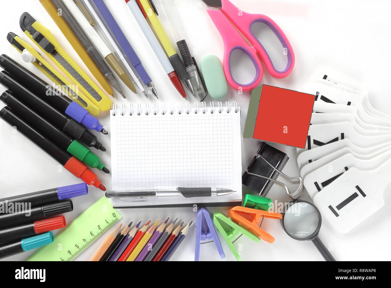 opened Notepad and office supplies on white background.photo with copy ...