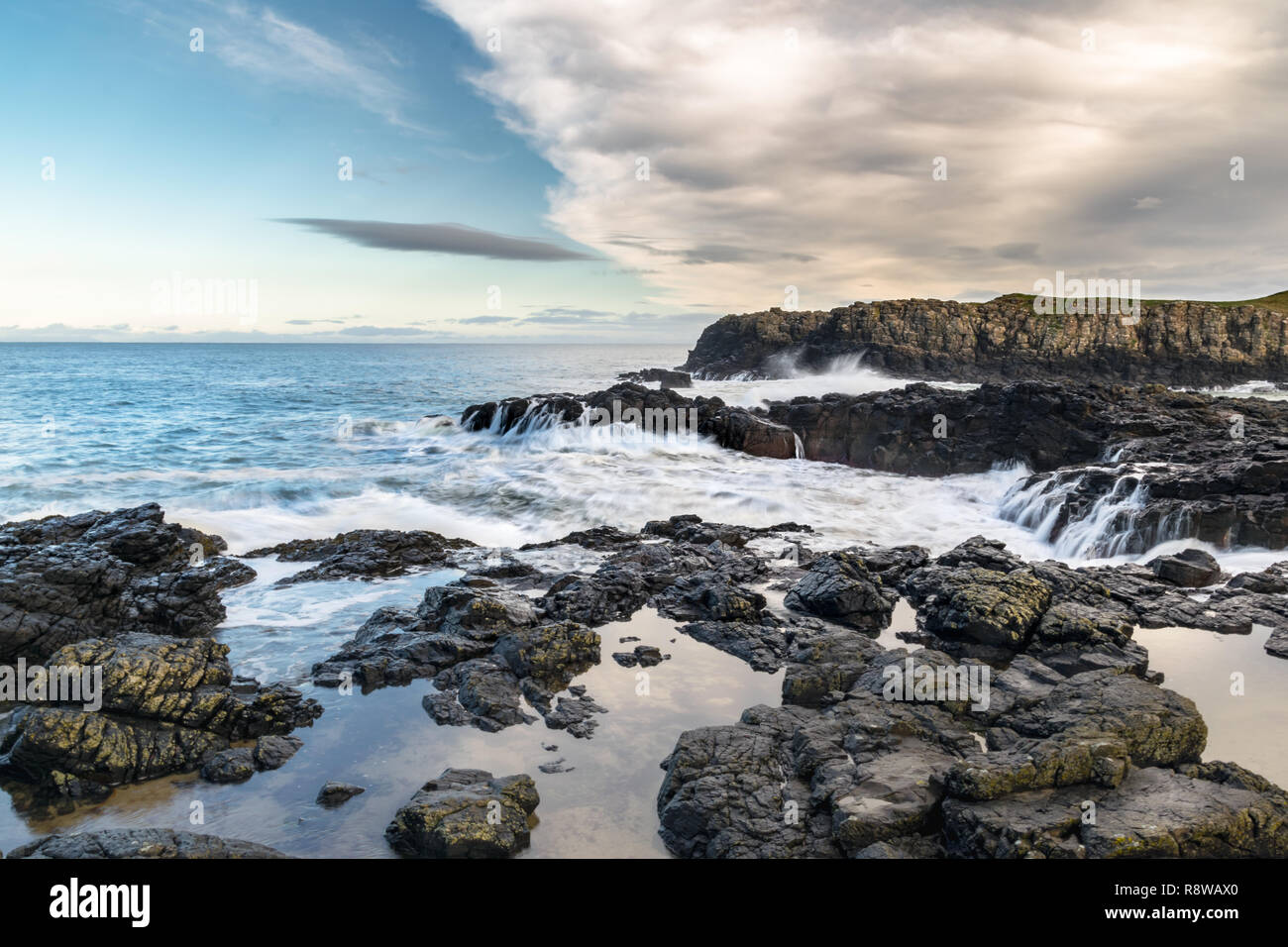 This is a picture of a rough sea smashing up on to a rocky coast Stock ...