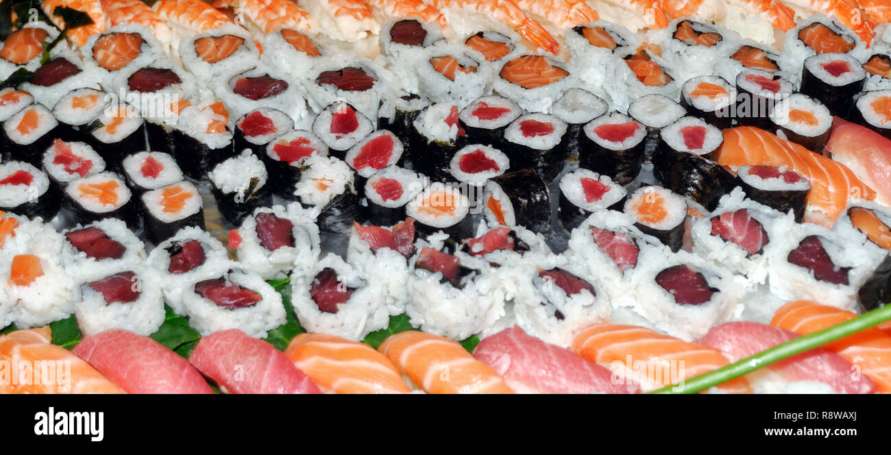 Table full of sushi in japanese style good for health Stock Photo - Alamy
