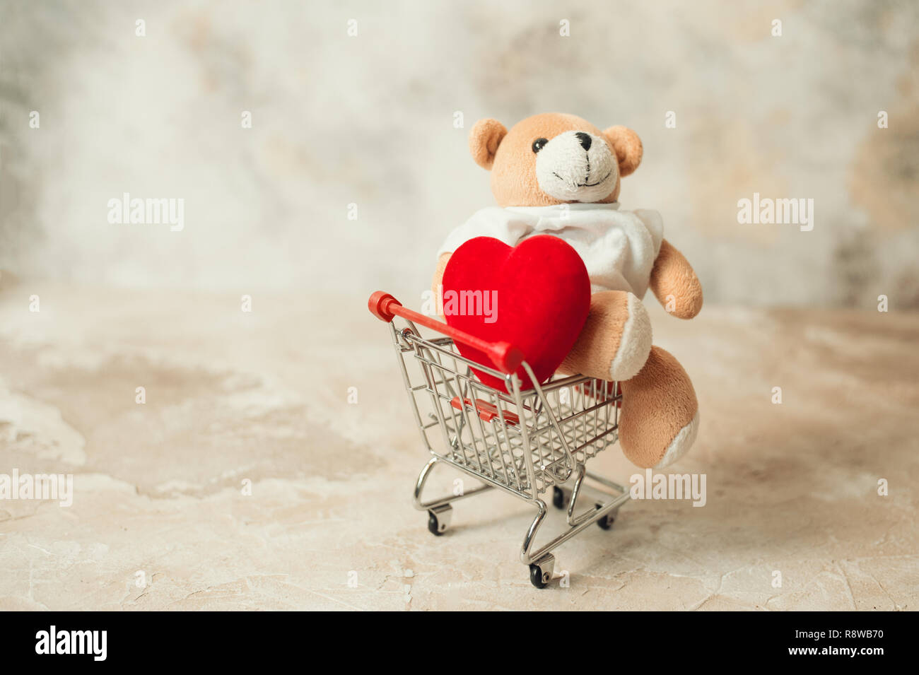 Valentine's Day shopping concept. White heart and gift with red ribbon ...