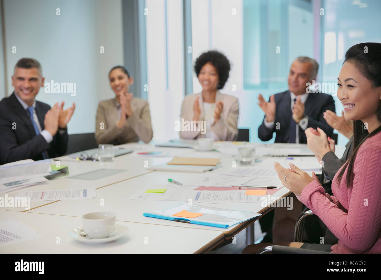 Smiling business people clapping in conference room meeting Stock Photo ...